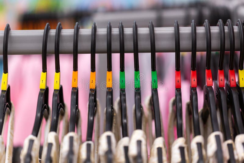 Close Up of a Clothing Rack with Hangers Showing Different Clothing ...