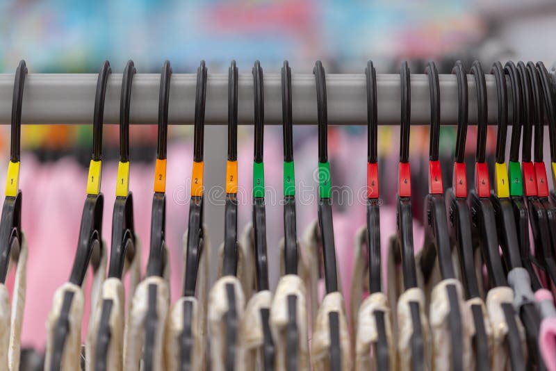 Close Up of a Clothing Rack with Hangers Showing Different Clothing ...