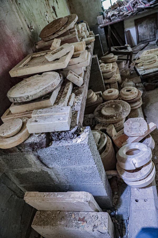 Stack of Abandoned Stone Molds and Plaster Forms in Dusty Workshop ...