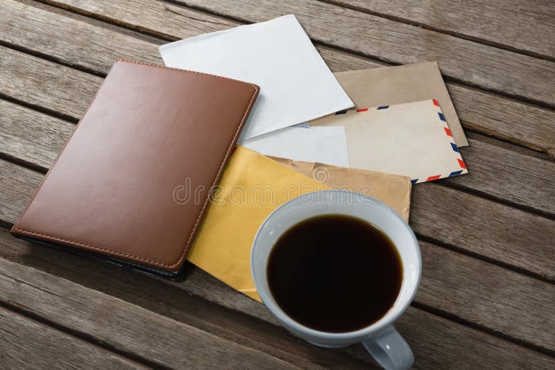 Coffee with Various Envelopes and Diary on Wooden Plank Stock Image ...