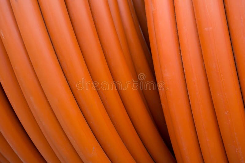 Close-up of Several Bright Orange PVC Pipes Stacked Together. the Pipes ...