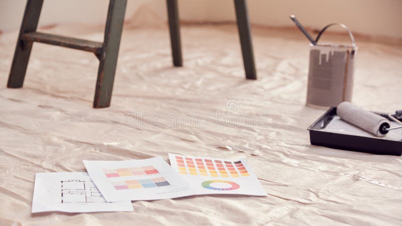 Close Up of Color Charts with Paint Roller and Step Ladder in Room ...