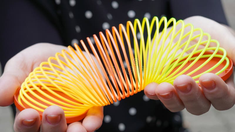 Close Up of Colorful Rainbow Toy in Hands Stock Photo - Image of rings ...
