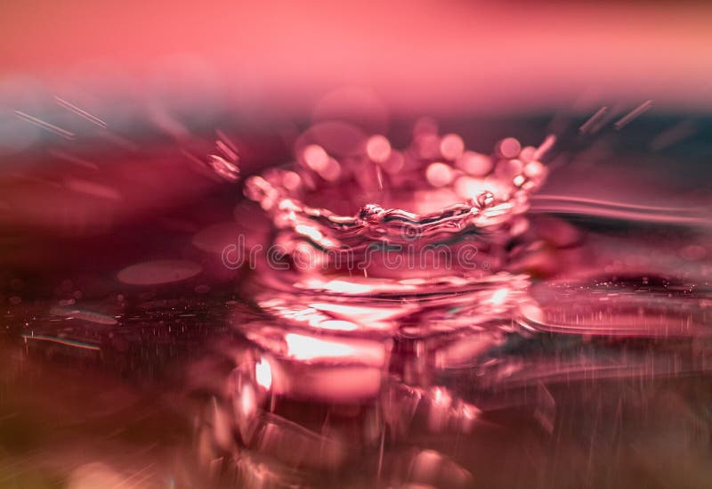 Colorful Water Drop Splash on Shiny Pink Background Stock Photo - Image ...