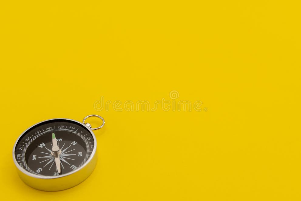 Close-Up of Compass Against Yellow Background Stock Image - Image of ...