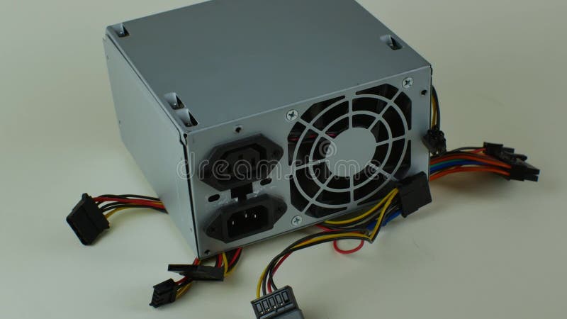 Close-up of a Computer Power Supply on a Light Background with Multi ...