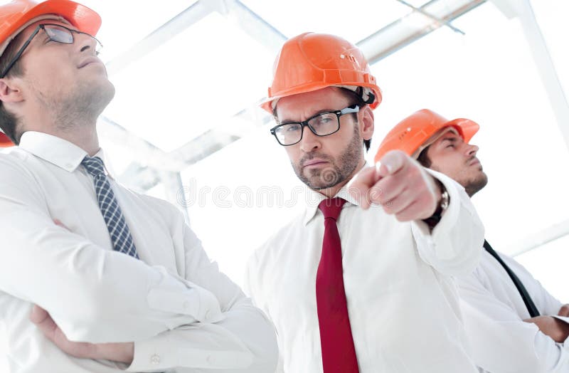 Close Up.a Confident Businessman in a Safety Helmet Pointing at You ... Close Up.a Confident Businessman in a Safety Helmet Pointing at You ...