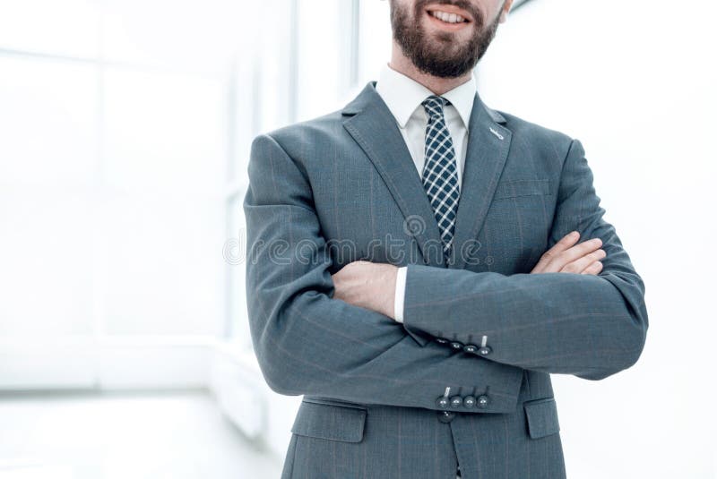 Close Up.confident Businessman Standing in a Bright Office Stock Photo ... Close Up.confident Businessman Standing in a Bright Office Stock Photo ...