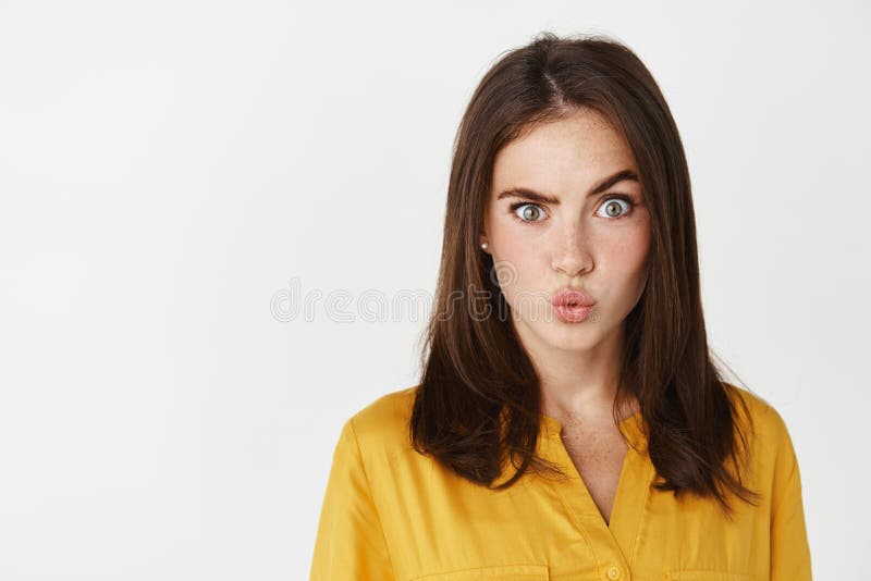 Close-up of Confused and Intrigued Young Woman Raising an Eyebrow ... Close-up of Confused and Intrigued Young Woman Raising an Eyebrow ...