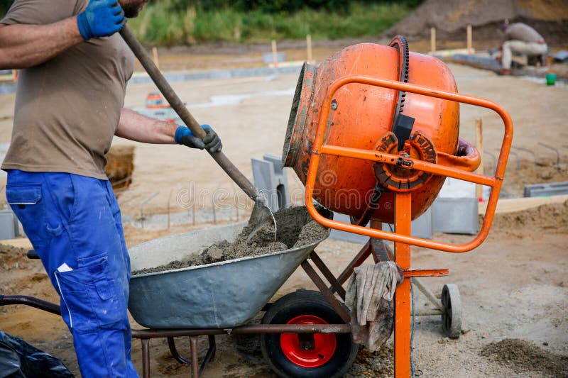 Constriction Worker Making Concrete in an Orange Mixer Stock Photo ...