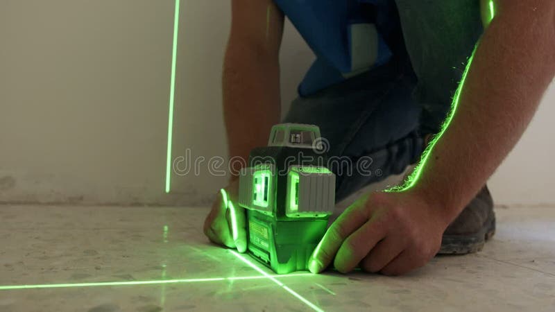 Close Up of Construction Worker Using a Laser Level To Measure and Mark ...