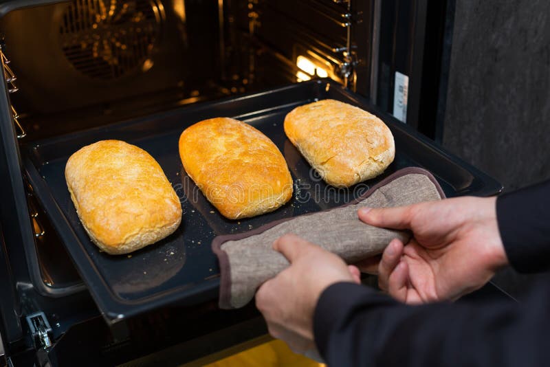 Close-up. the Cook Prepares Bread in an Electric Oven. Stock Image ...