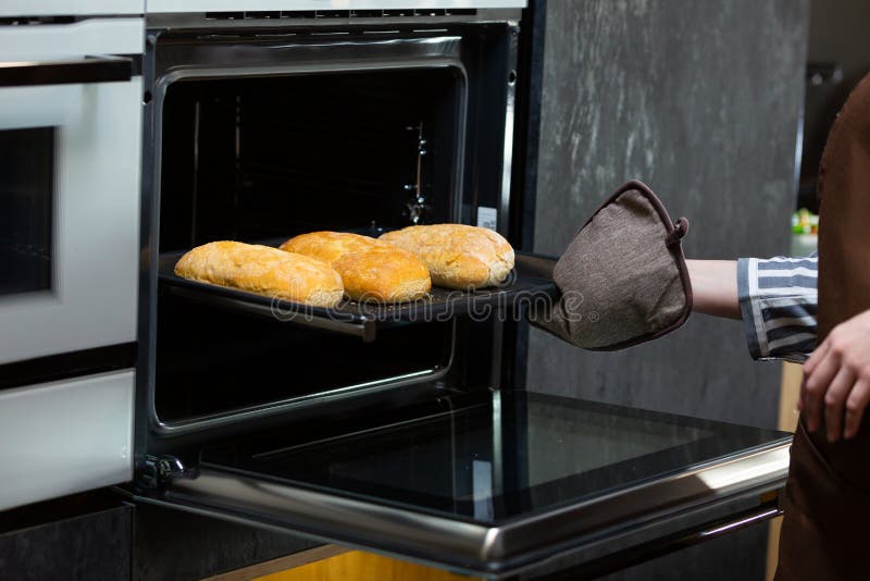 Close-up. the Cook Prepares Bread in an Electric Oven. Stock Image ...