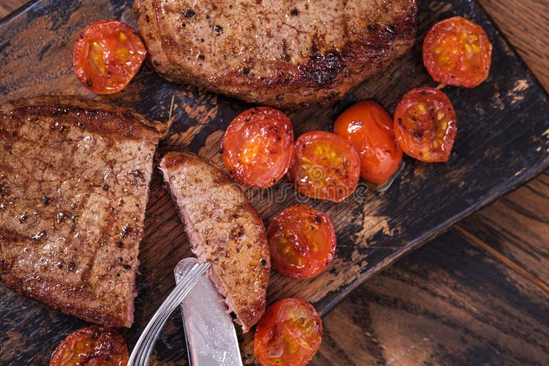 Close-up Cooked and Sliced Beef Steak with Tomato Stock Image - Image ...