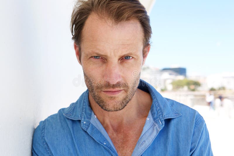 Close Up Cool Older Man Leaning Against Wall and Staring Stock Photo ...