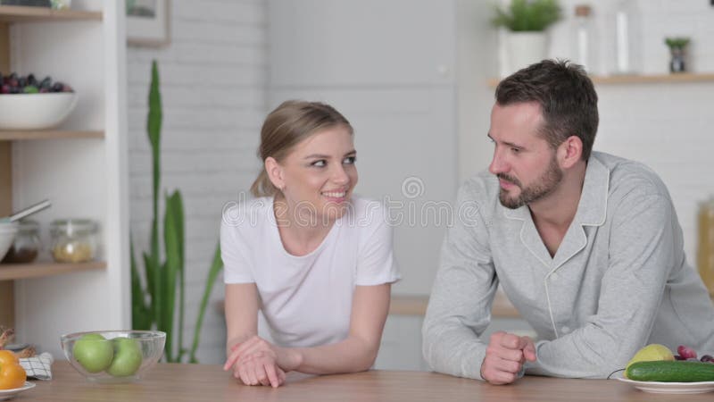 Close Up of Couple Having Conversation while in Kitchen Stock Photo ...