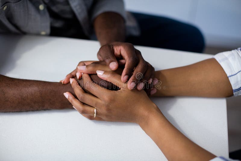 Close-up of Couple Holding Hands on Table in Kitchen Stock Image ...