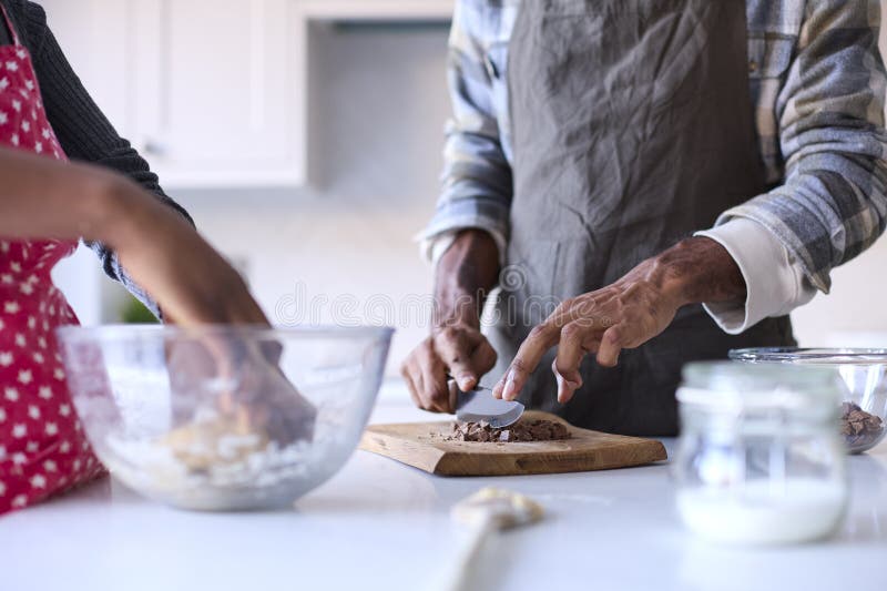 Close Up of Couple at Home Baking Cake Together in Kitchen Stock Photo ...