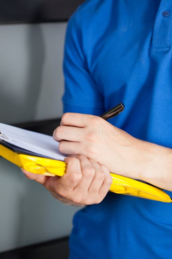 Close-up of a Courier Writing on Clipboard Stock Photo - Image of ...
