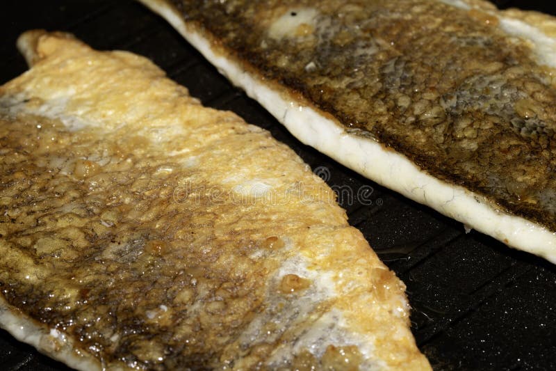 Close Up of Crispy Fish Skin Frying in a Pan Being Cooked Stock Image ...