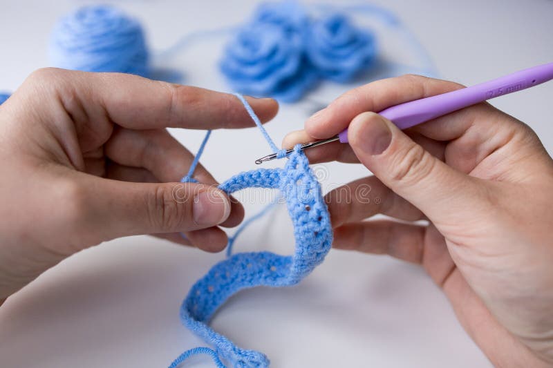 Close Up of Crochet Work in Progress with Blue Yarn and Crochet Hook ...