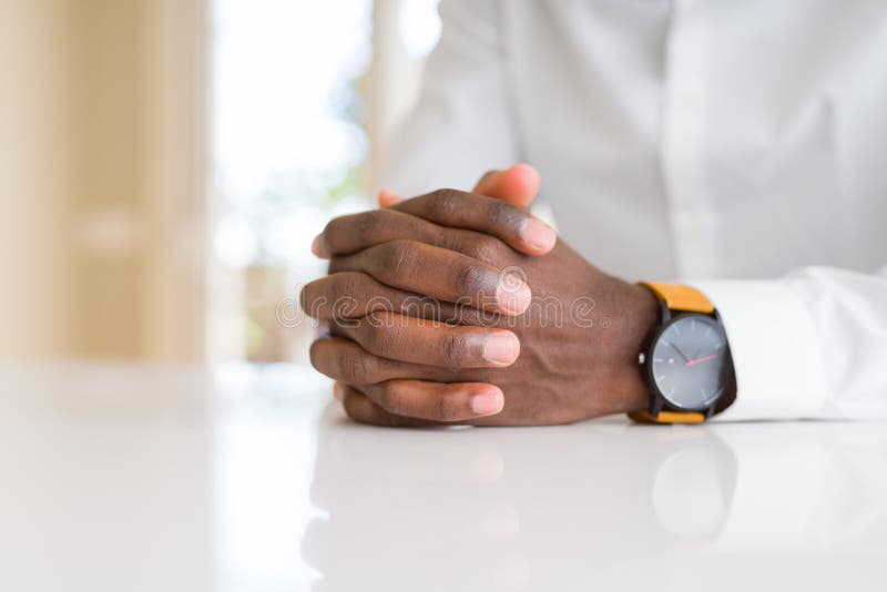 Close Up of Crossed Hands of African Man Over Table Stock Image - Image ...