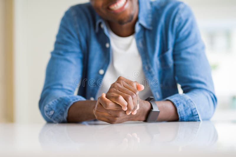 Close Up of Crossed Hands of African Man Over Table Smiling Stock Photo ...