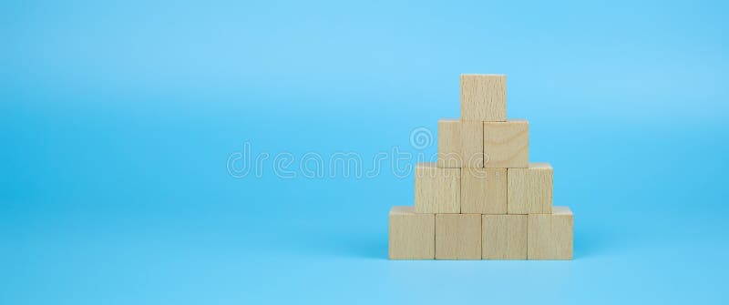 Close-up Cube Wooden Block Toy Stack in Pyramid on Blue Background ...