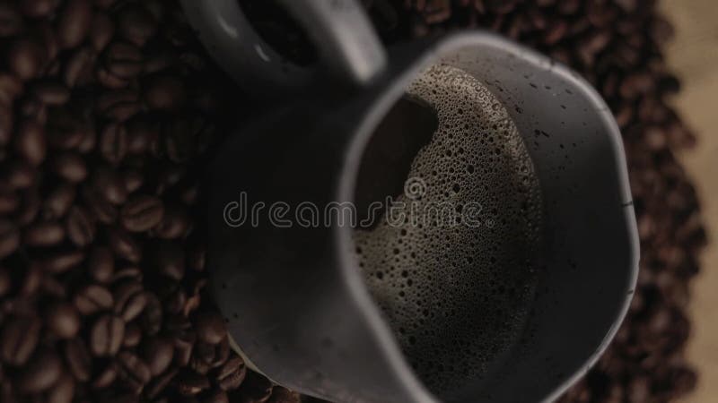Close Up of a Cup of Coffee with Background of Rotating Coffee Beans ...