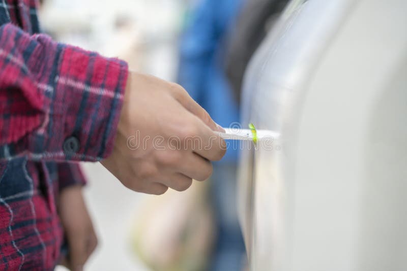 Close Up Customer Hand Pull a Ticket Number from Dispenser Machine To ...
