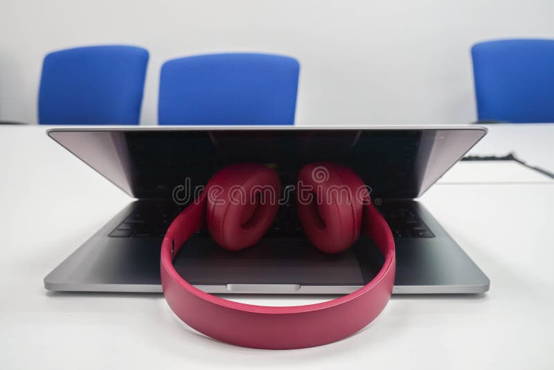 Cute Pink Wireless Headphone on Notebook Computer in Office Meeting ...