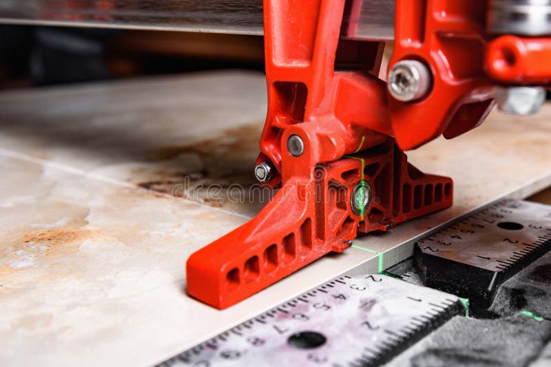 Close Up of Cutting Ceramic Tile with Red Manual Tile Cutter. Stock ...