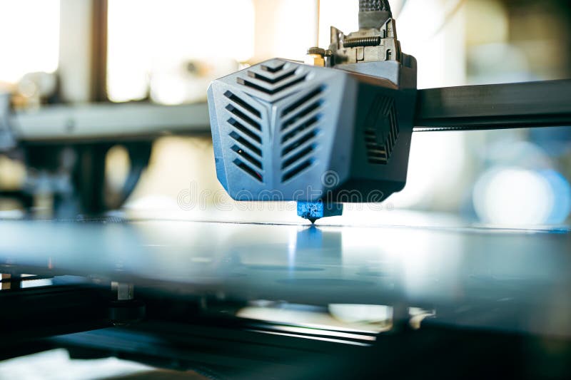 Close-up of a 3D Printer at Work, Focusing on the Print Head and the ...