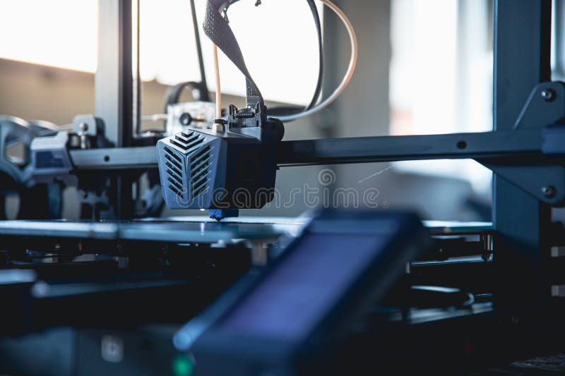 Close-up of a 3D Printer at Work, Focusing on the Print Head and the ...