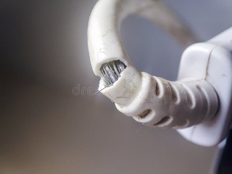 Close-up of a Damaged Electrical Cable Showing Exposed Wires and Frayed ...