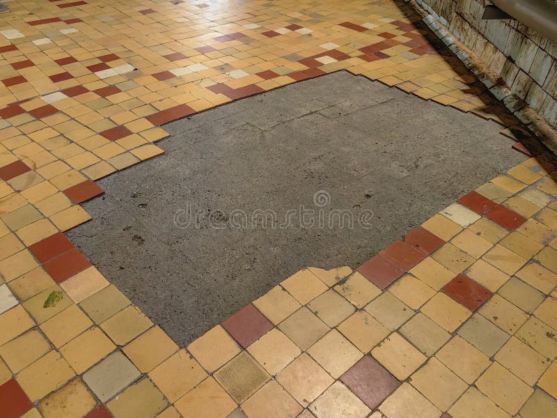 Close-up of Damaged Floor Tiles Revealing a Concrete Foundation ...
