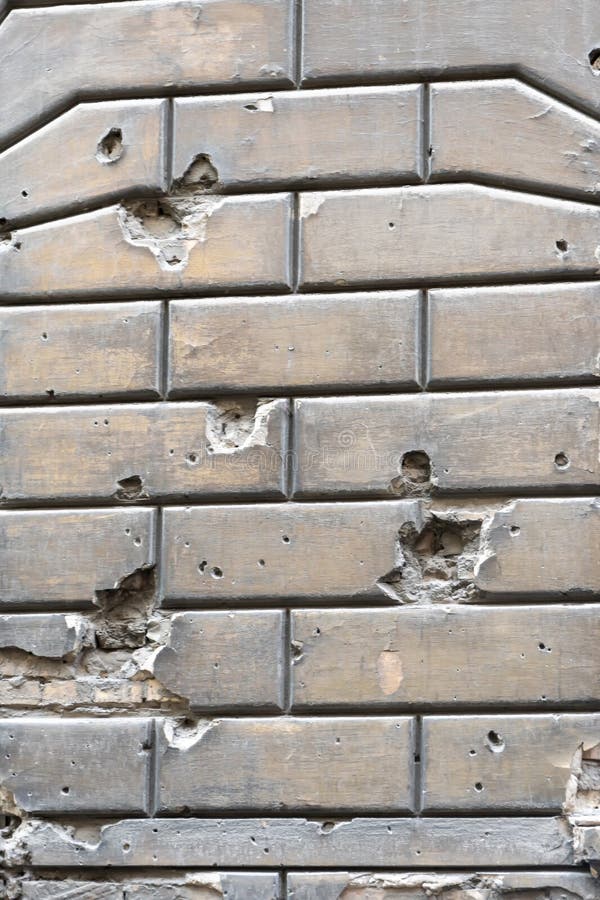 Close-up of Damaged Masonry with Bullet and Shell Holes. the Wall is ...
