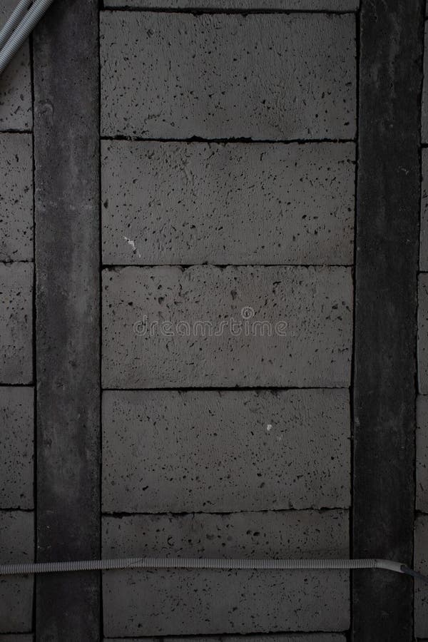A Close-up of a Dark Gray Cement Block Wall with Visible Texture and ...