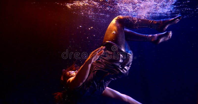 Close-up of a Dark-haired Middle-aged Woman Falling in a Studio Under ...