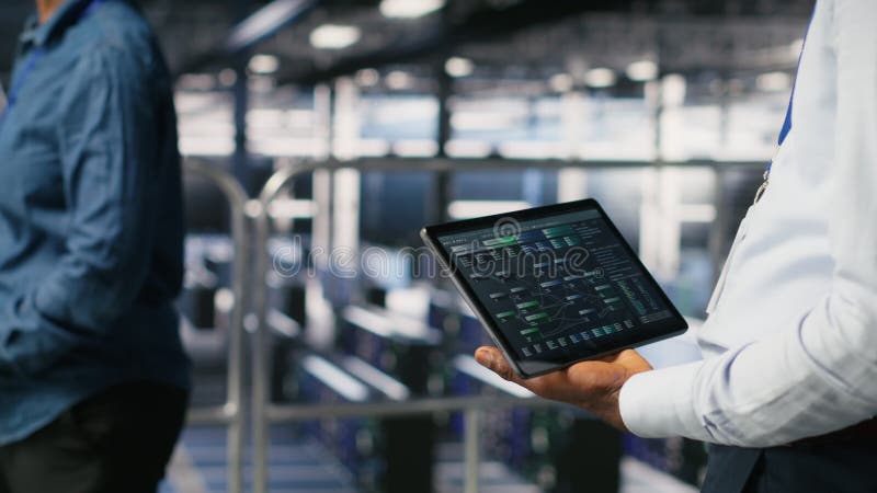 Close Up of Data Center Admin Using Tablet To Reviewing Machine ...