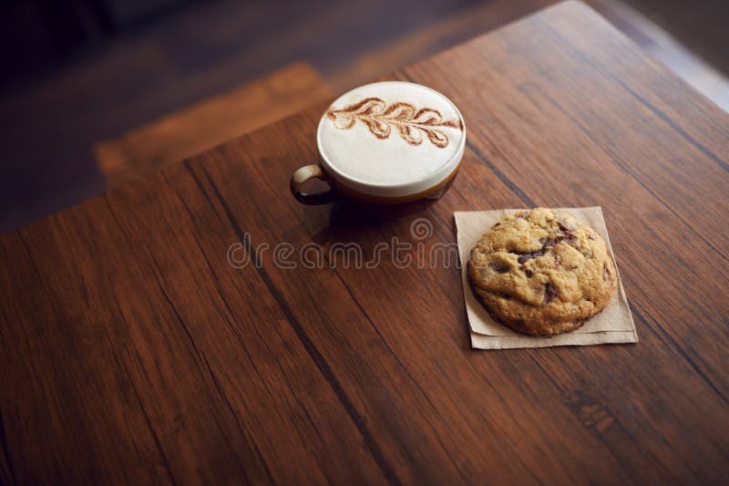 Close Up of Decorated Coffee and Cookie on Table in Coffee Shop Stock ...