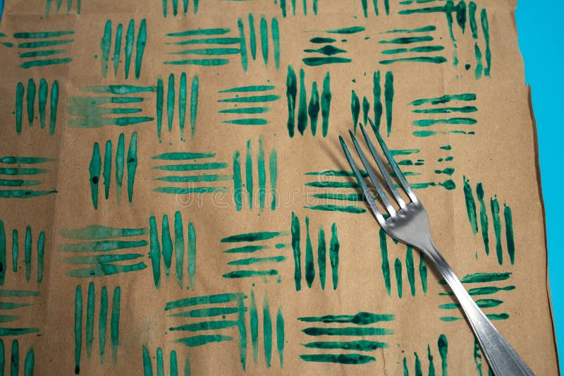 Close Up of Decorative Stamps with Fork in the Paint and Sheets of ...