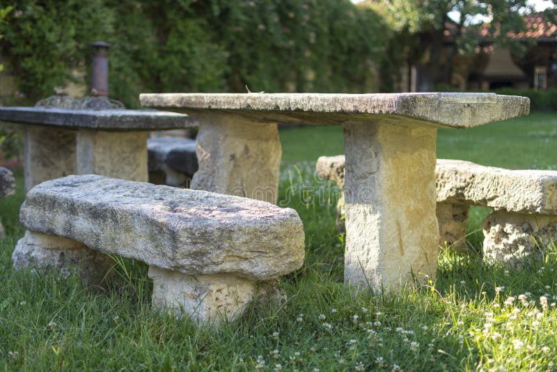 Close Up of a Decorative Stone Bench and Table Against Blurry ...