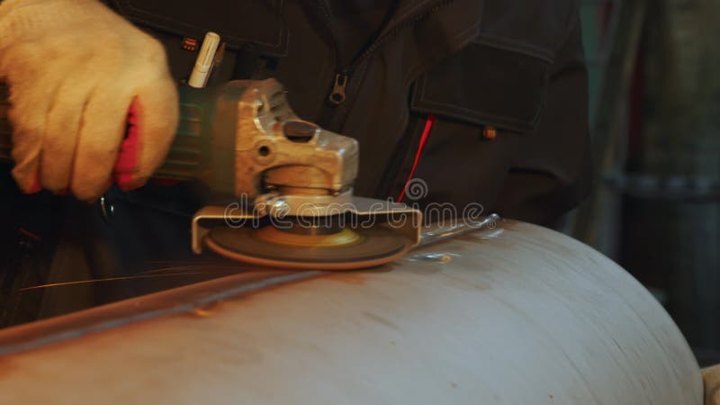 Close Up of a Dedicated Worker Effectively Grinding a Metal Pipe Using ...