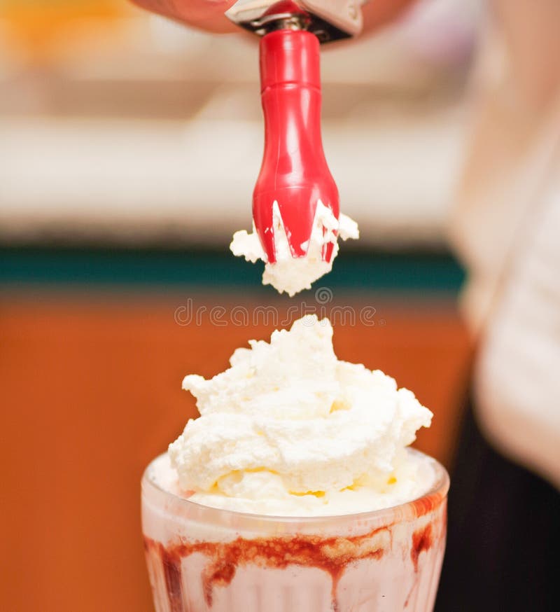 Close Up of a Delicious Homemade Milkshake Adding Some Cream on Top ...