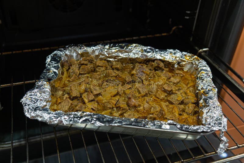 Close Up of Delicious Pieces of Meat Baking in the Oven in the Kitchen ...