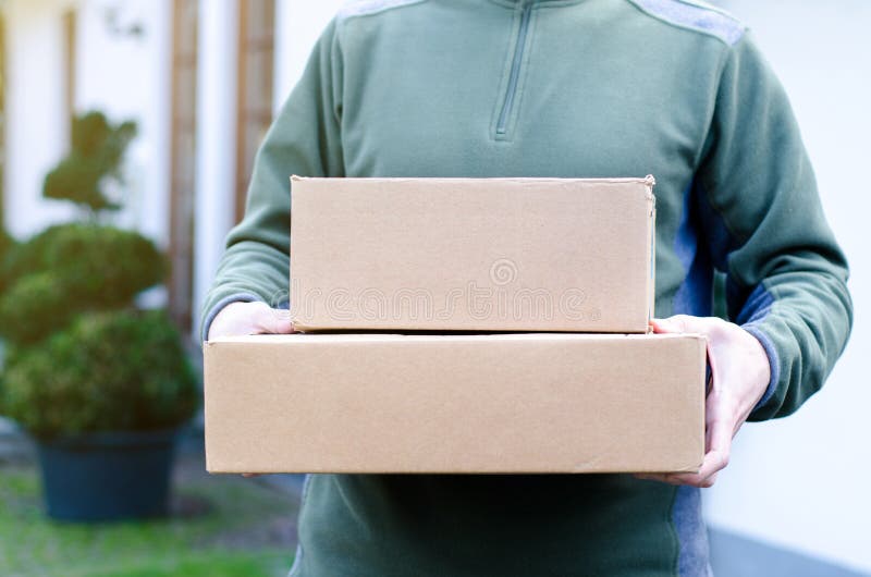 Close-up of Delivery Man Delivers Package Stock Photo - Image of house ...