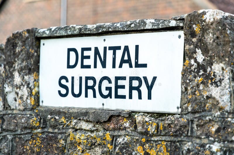 Close-Up of Dental Surgery Sign on Rustic Wall with Yellow Lichen Stock ...