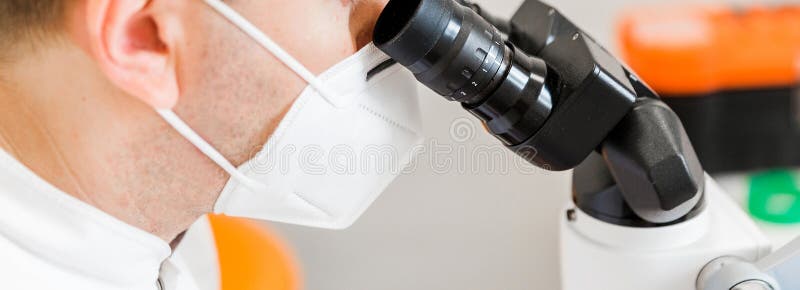 Dentist Observing through Microscope in Clinic Stock Image - Image of ...