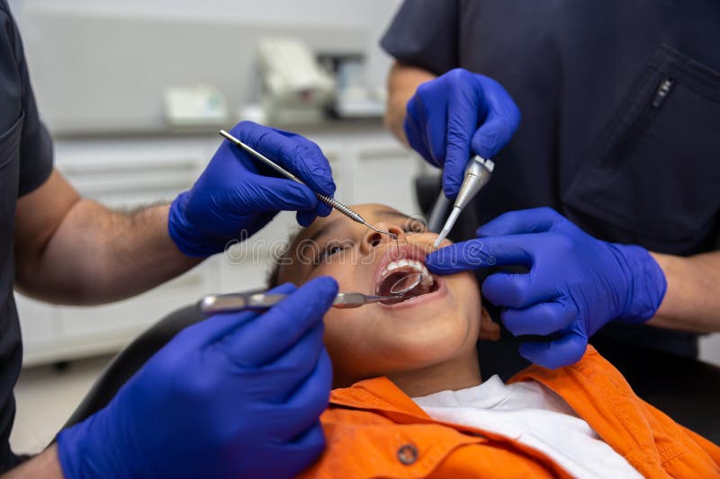 Close Up of Dentists Working on Teeth of a Little Boy Stock Image ...